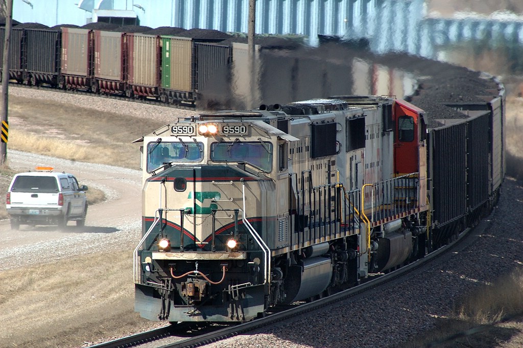 BN 9590 and Warbonnet SD75I work a loaded coal train eastbound